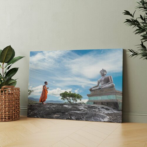 Картина на холсте "Женщина, стоящая рядом с большой статуей будды" 30x40 см. Интерьерная, на стену.