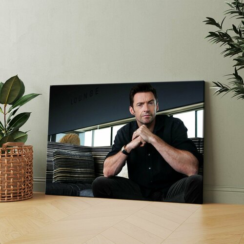 Картина на холсте (Мужчина сидит на диване, на заднем плане кот) 30x40 см. Интерьерная, на стену.